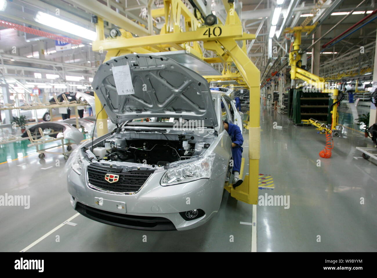 Chinese factory workers assemble Geely Emgrand EC718 cars on the ...
