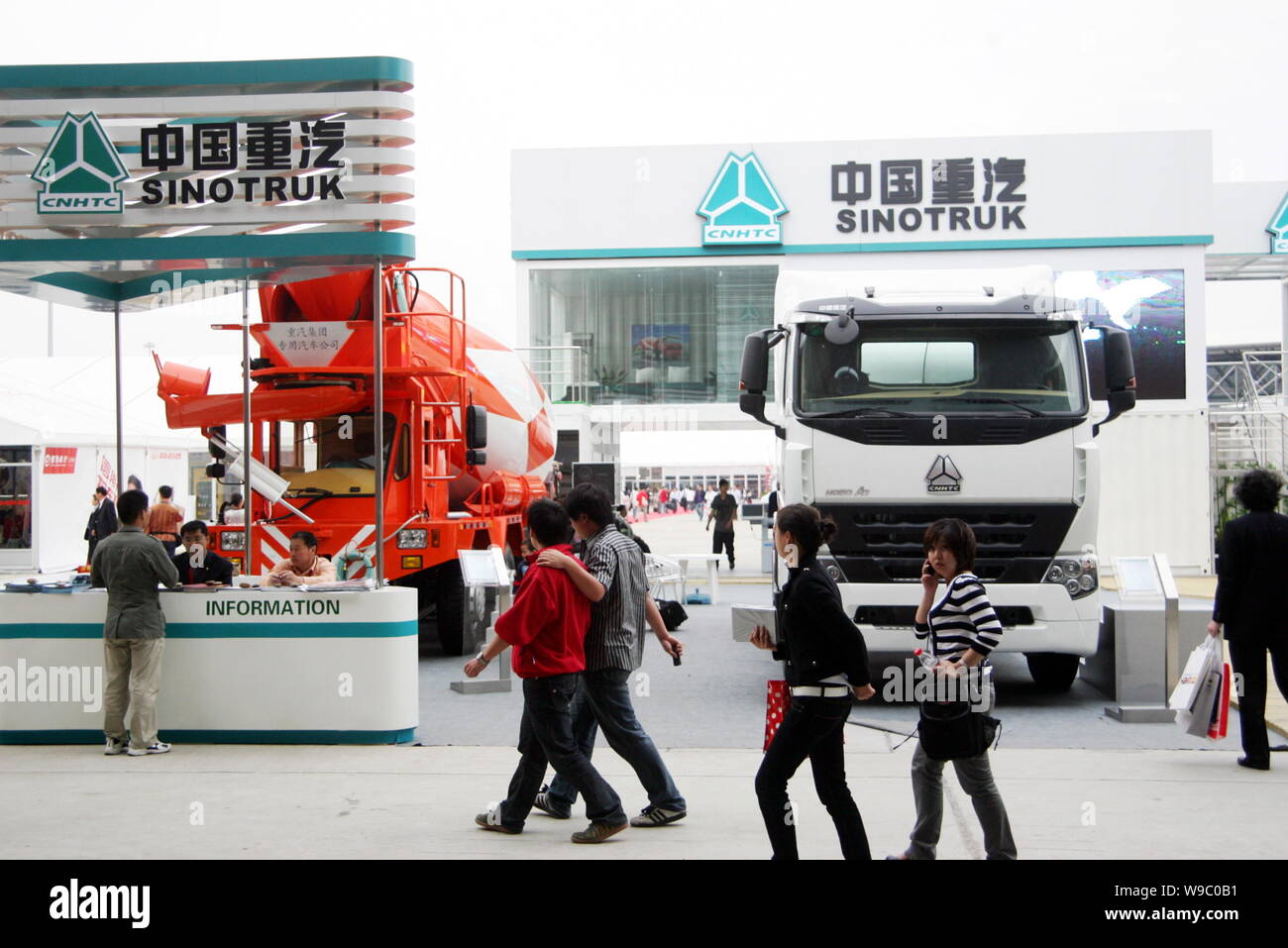 --FILE--Visitors walk past the stand of China National Heavy Duty Truck ...