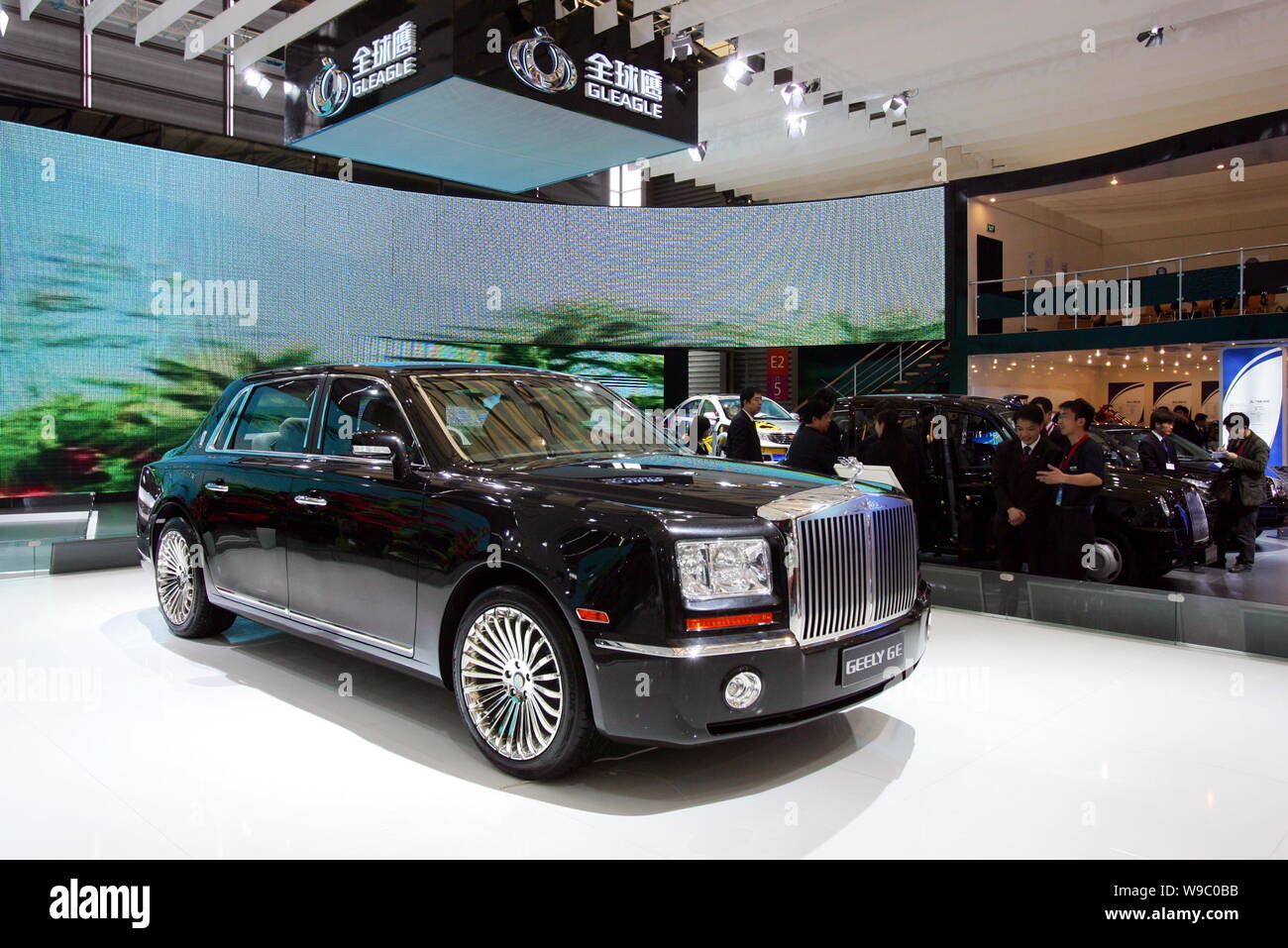 Visitors look at a Geely GE at the 13th Shanghai International ...