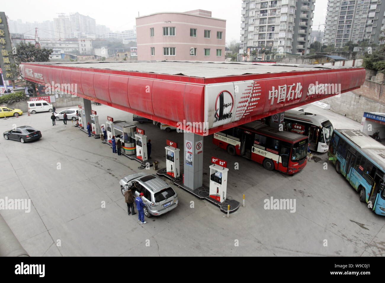 --FILE--Cars and buses are seen being refueled at a gas station of ...