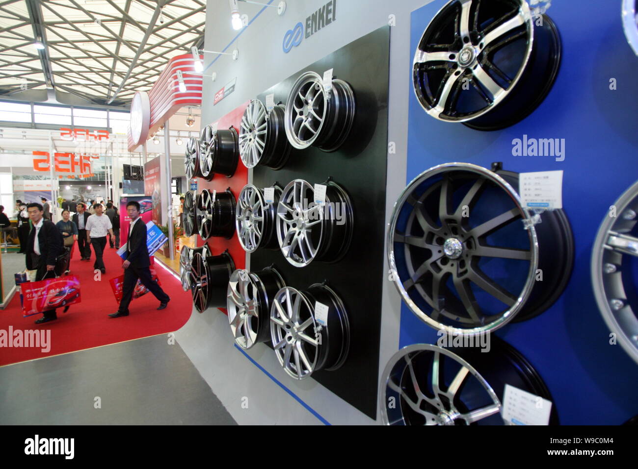 --FILE--Chinese visitors walk past car rims on display during an ...