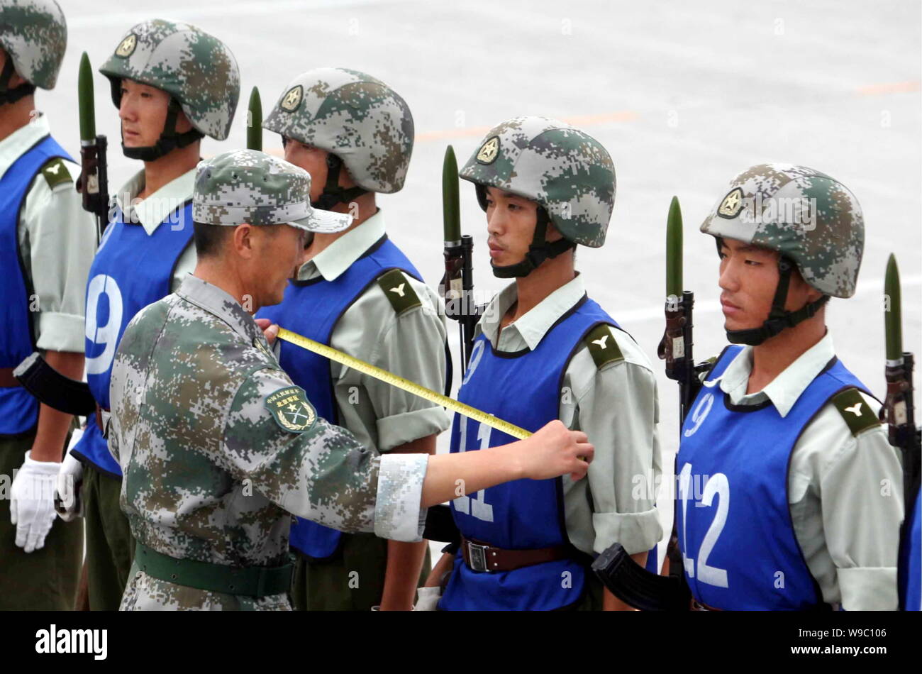 A Chinese PLA officer measures the heights of chests of Chinese ...