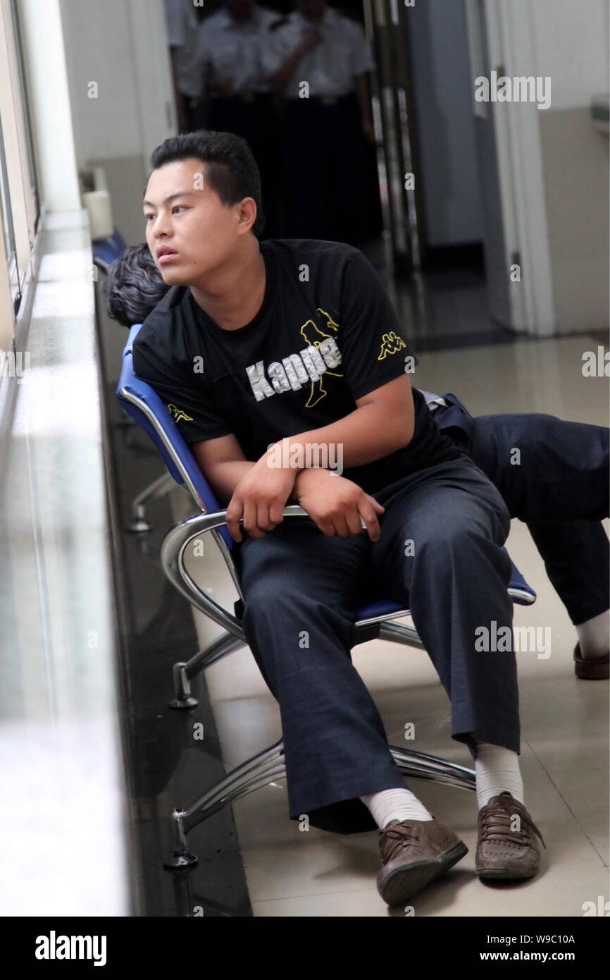 Li Zhiguo, father of the newborn Siamese twin sisters, is seen waiting ...