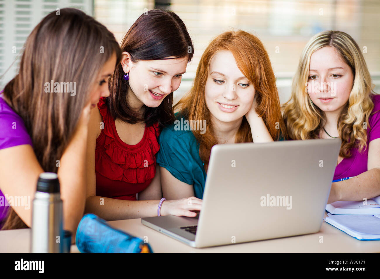 College students working on their homework/having a chat in between the ...