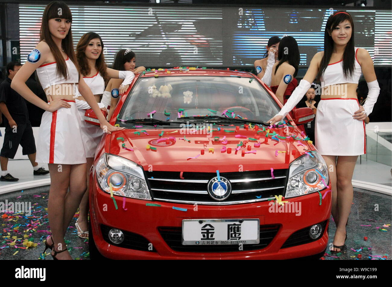 --FILE--Chinese models pose with a Geely Golden Eagle at a car show in ...