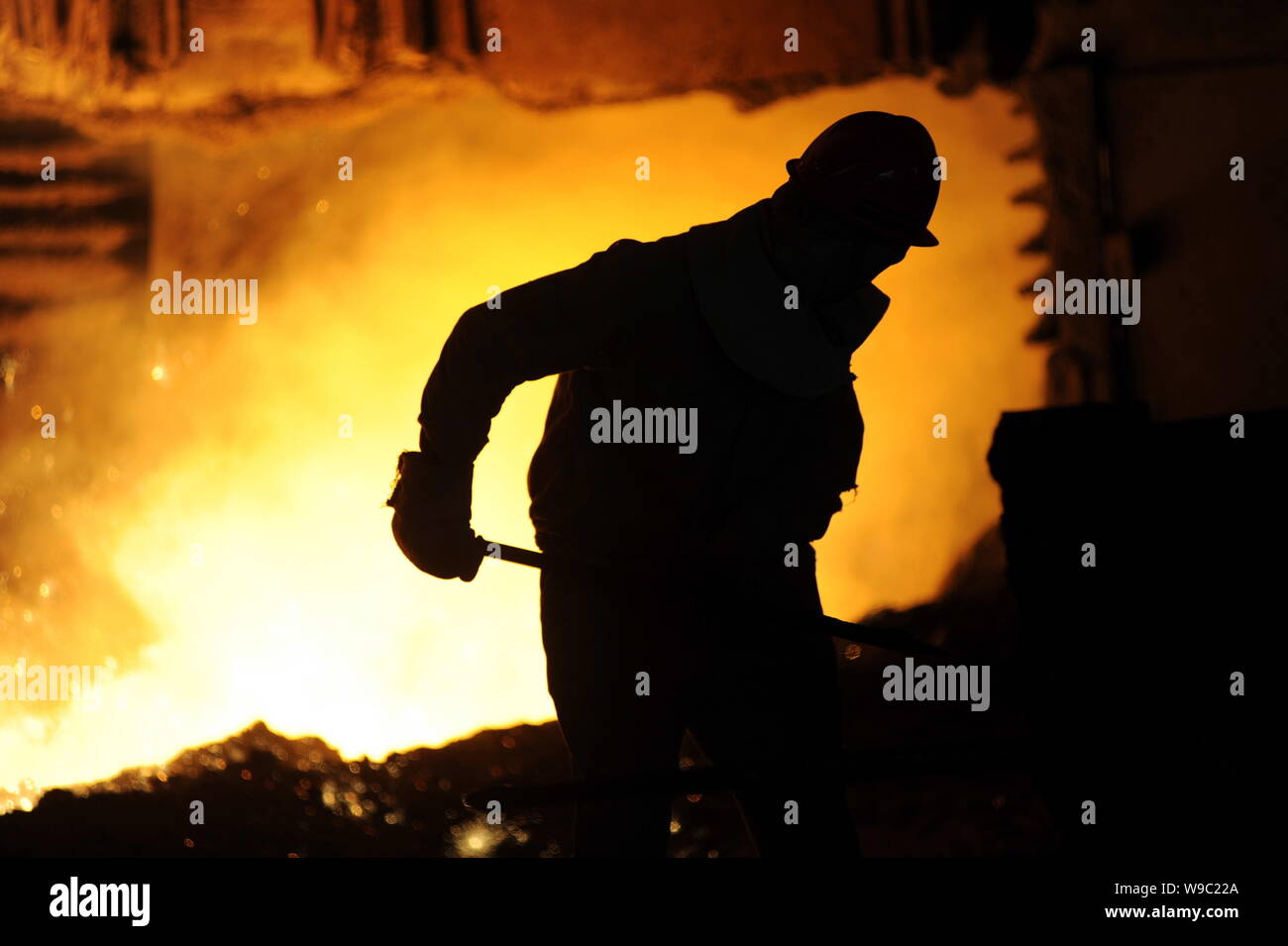 --FILE--A Chinese factory worker monitors the production of steel at a ...