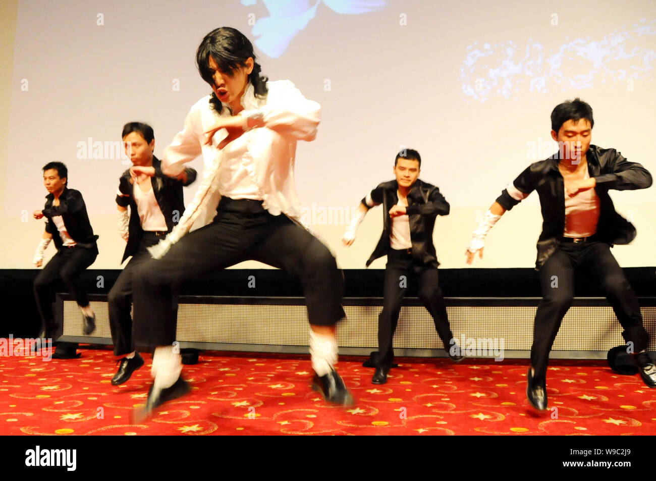 Chinese dancers imitating Michael Jackson perform during a ...