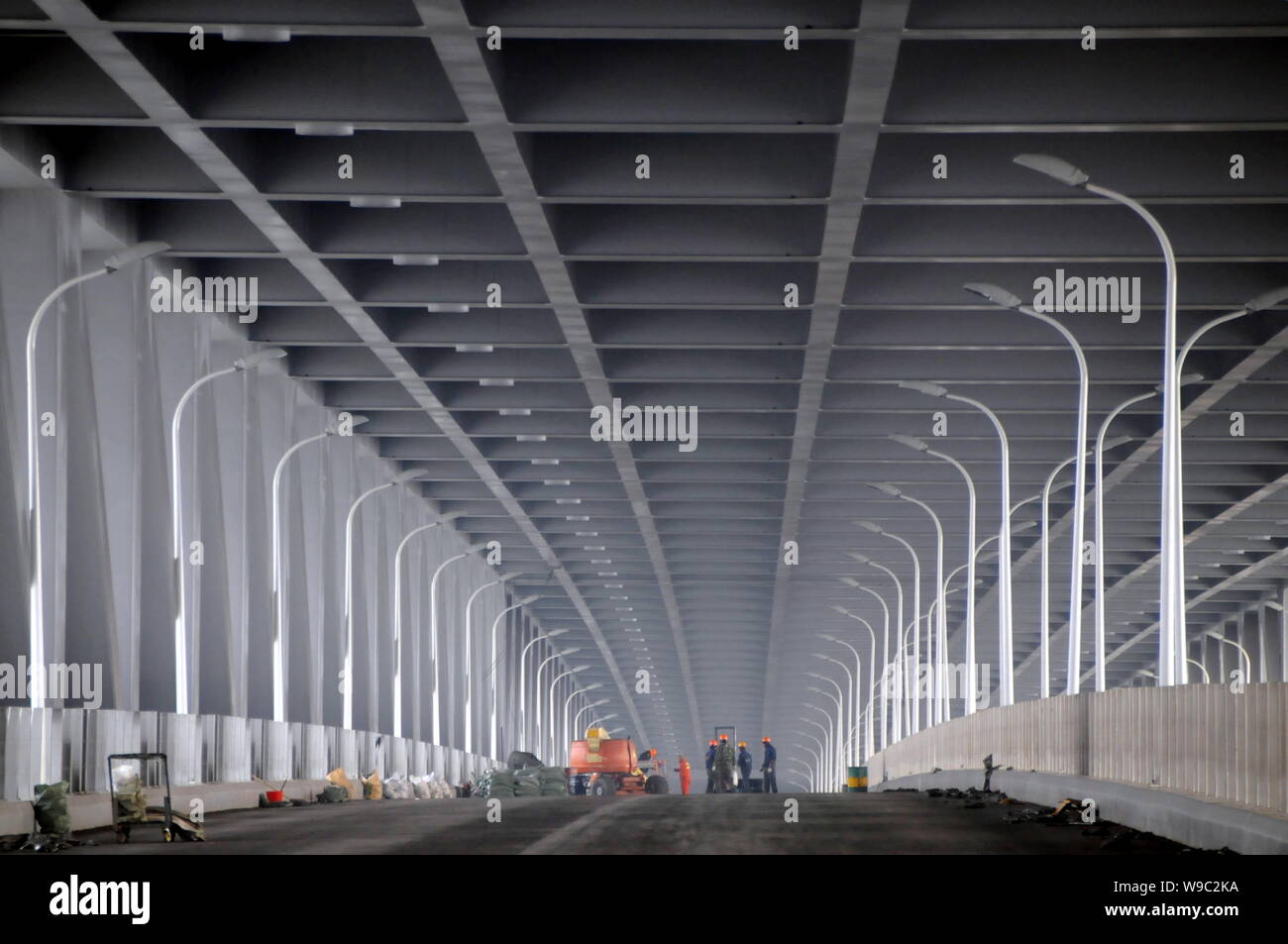 Chinese workers check and put final touches on the Minpu Bridge in ...