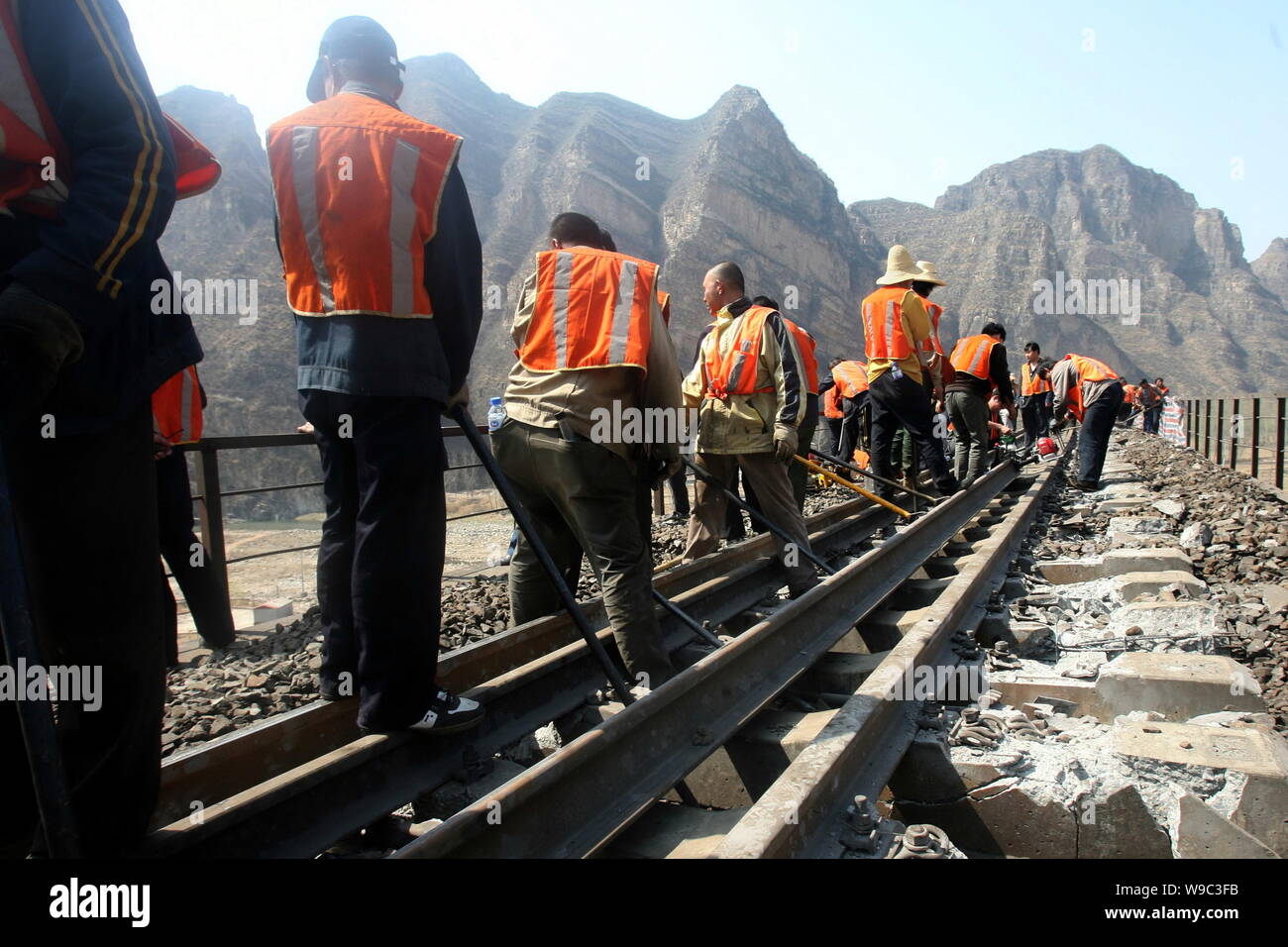 Chinese railway construction workers are seen repairing the broken ...