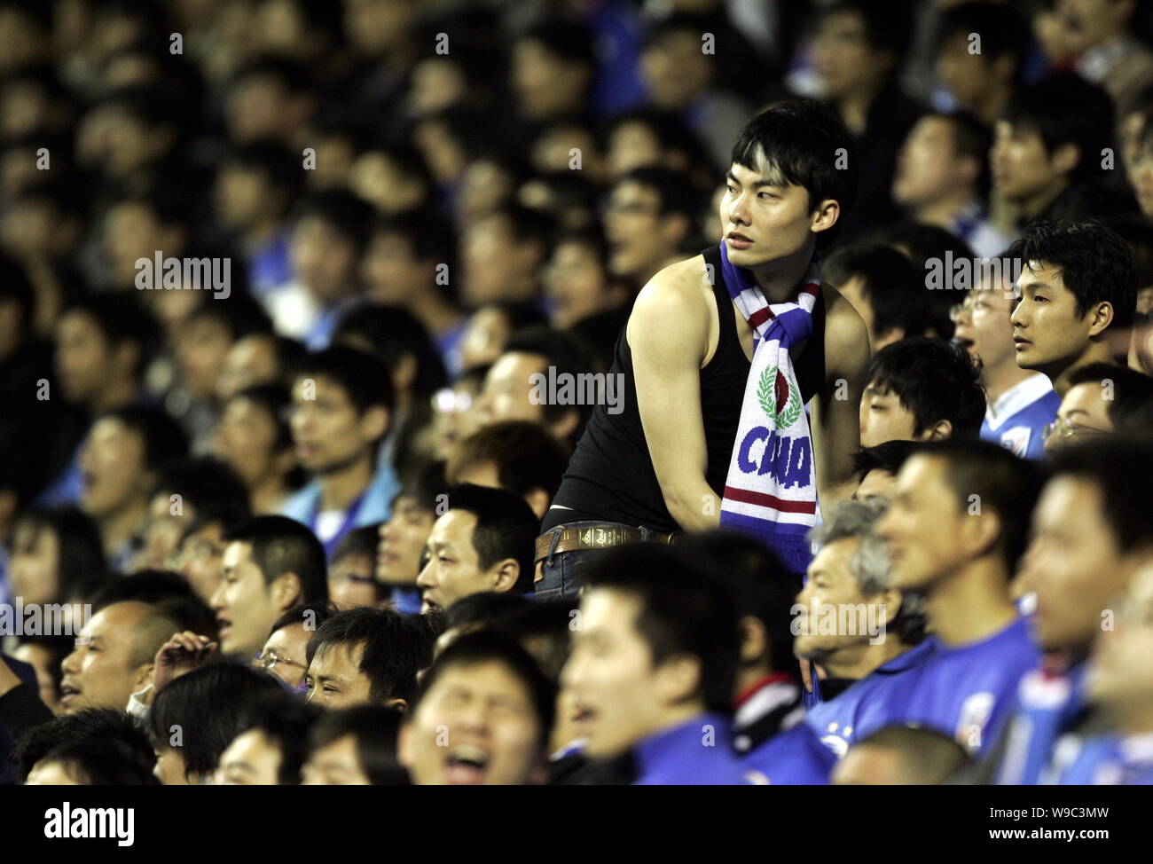 Chinese soccer fans of Shanghai Shenhua FC watch Shanghai Shenhua FC ...