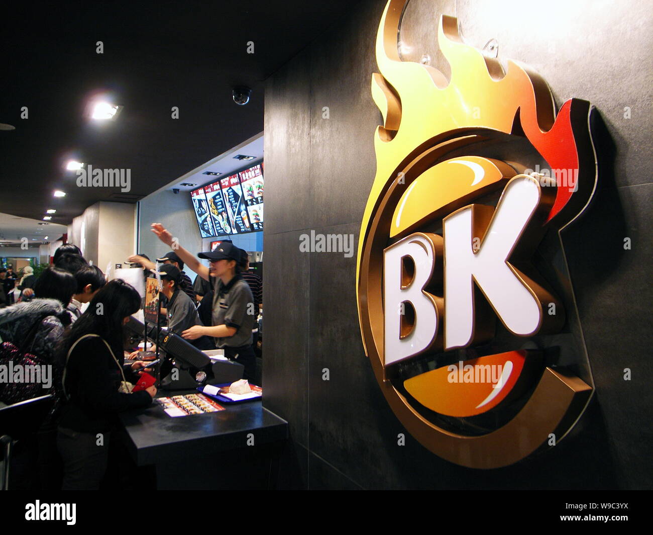 Customers crowd a newly-opened Burger King restaurant in Beijing, China ...
