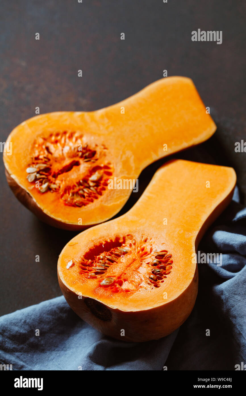 View on raw halves of butternut squash on a kitchen table. Seasonal ...