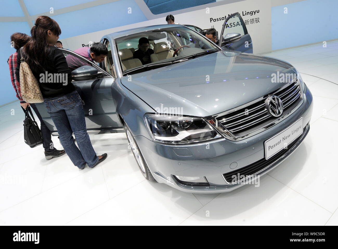 Visitors look at a Passat New Lingyu manufactured by Shanghai ...