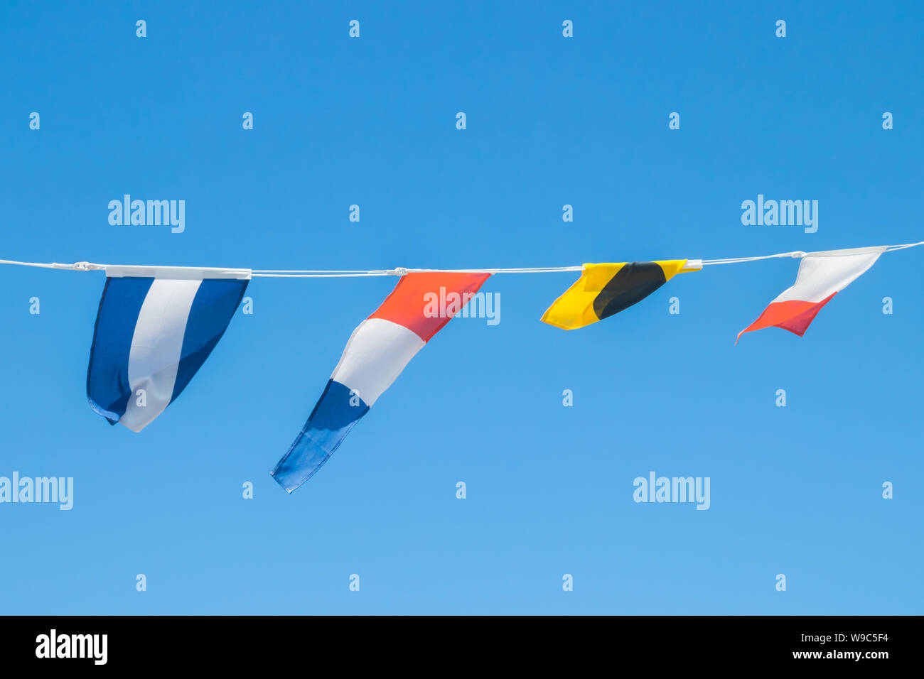 Nautical flags on the ship against blue sky Stock Photo - Alamy
