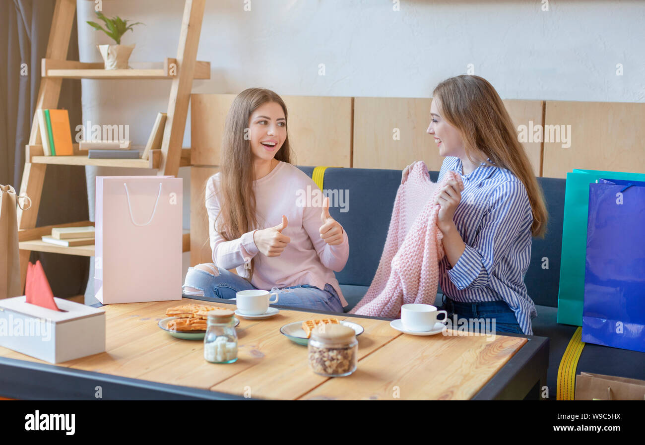 Pretty Girl Reacting With Thumbs Up To Girlfriend New Sweater Stock