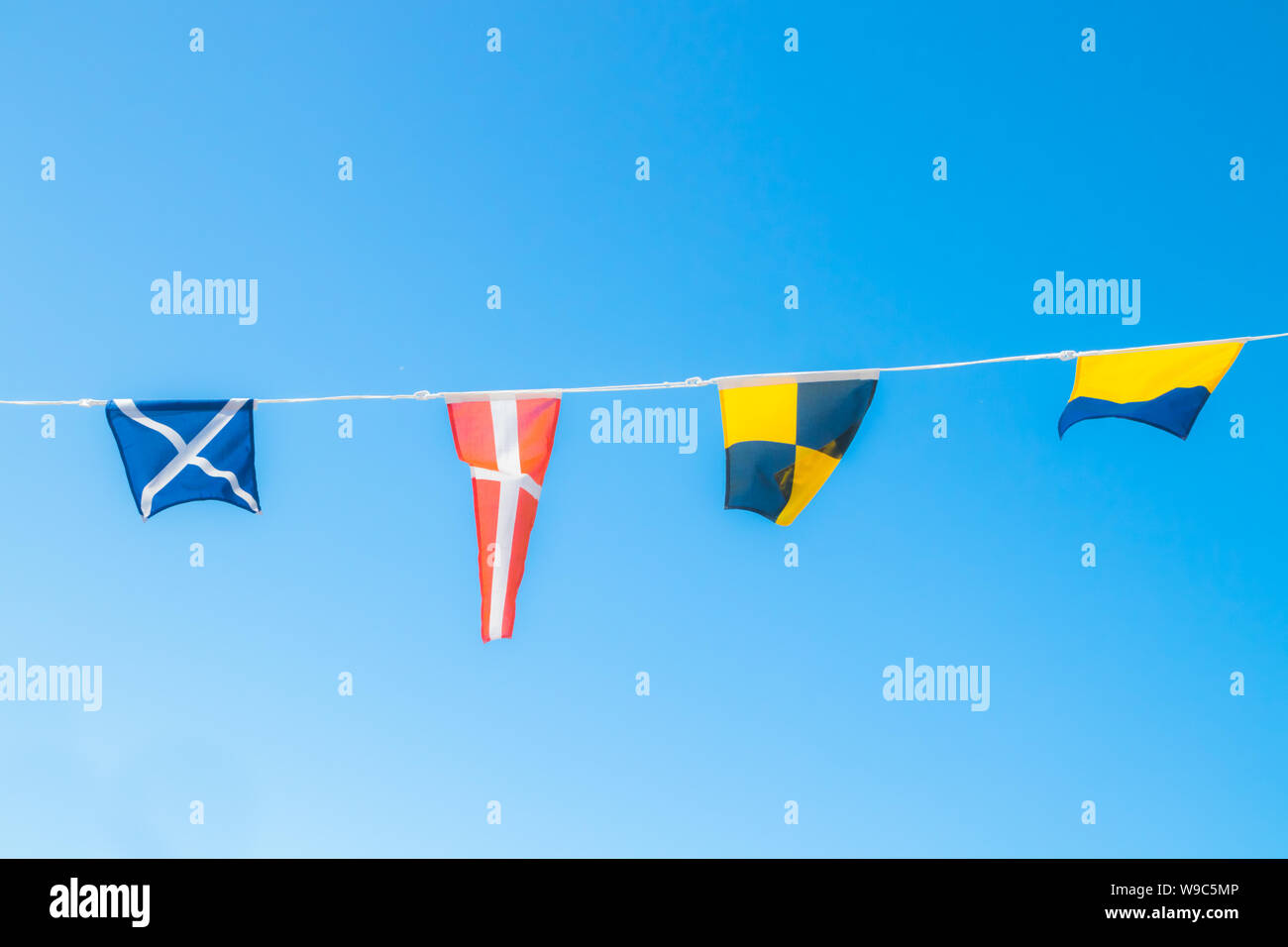 Nautical flags on the ship against blue sky Stock Photo - Alamy