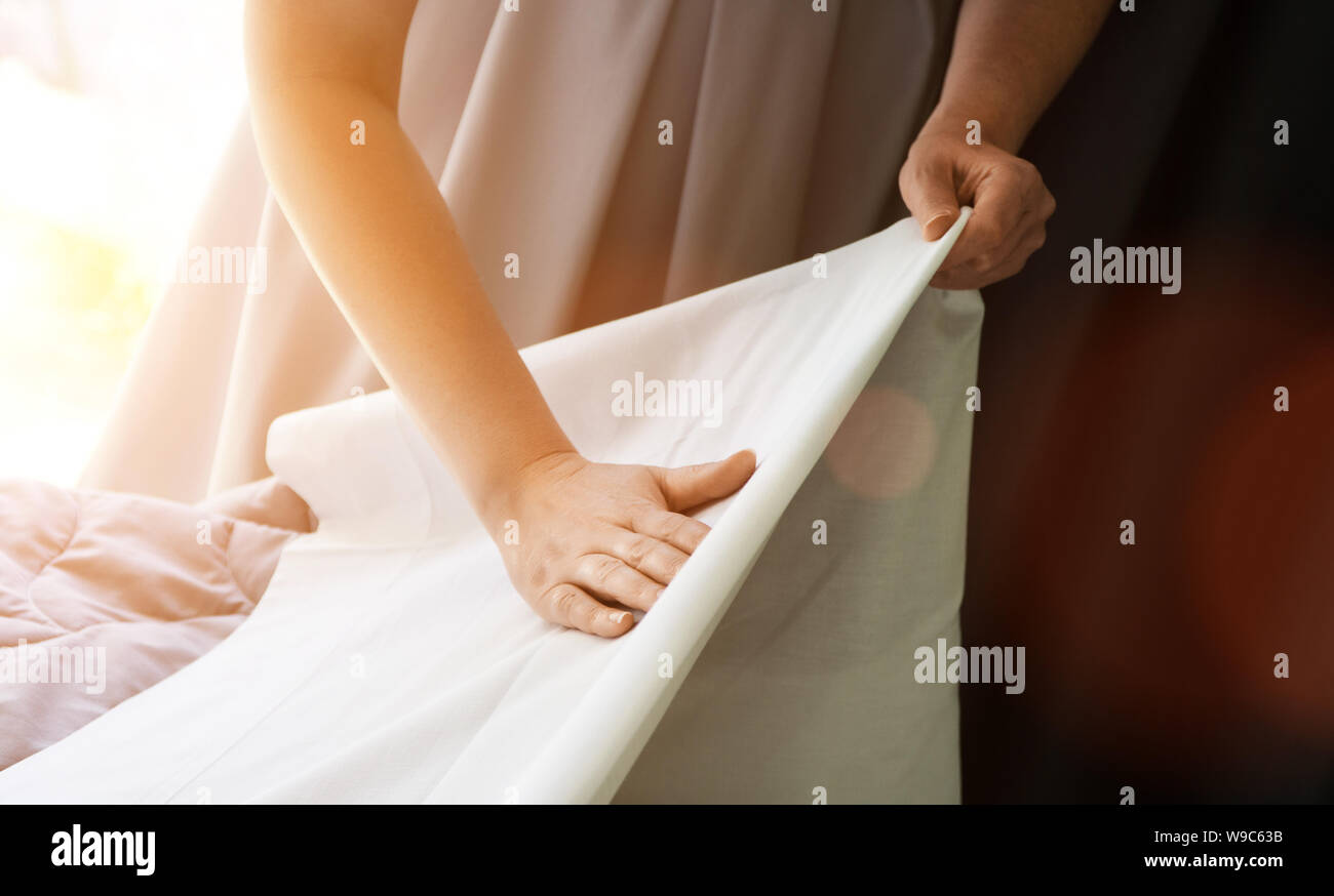 Room service. Woman making bed in hotel room Stock Photo - Alamy