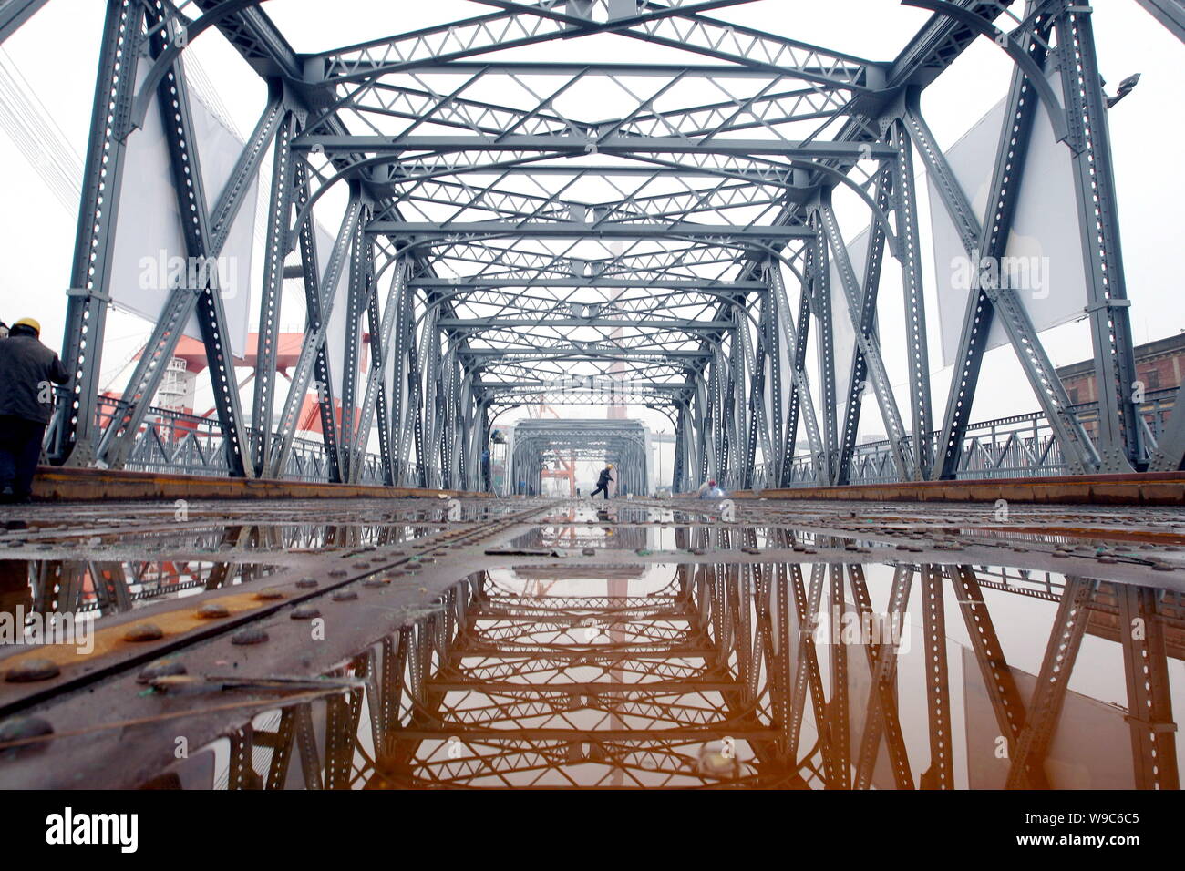 Chinese workers make final checks and repairs on the structure of the ...