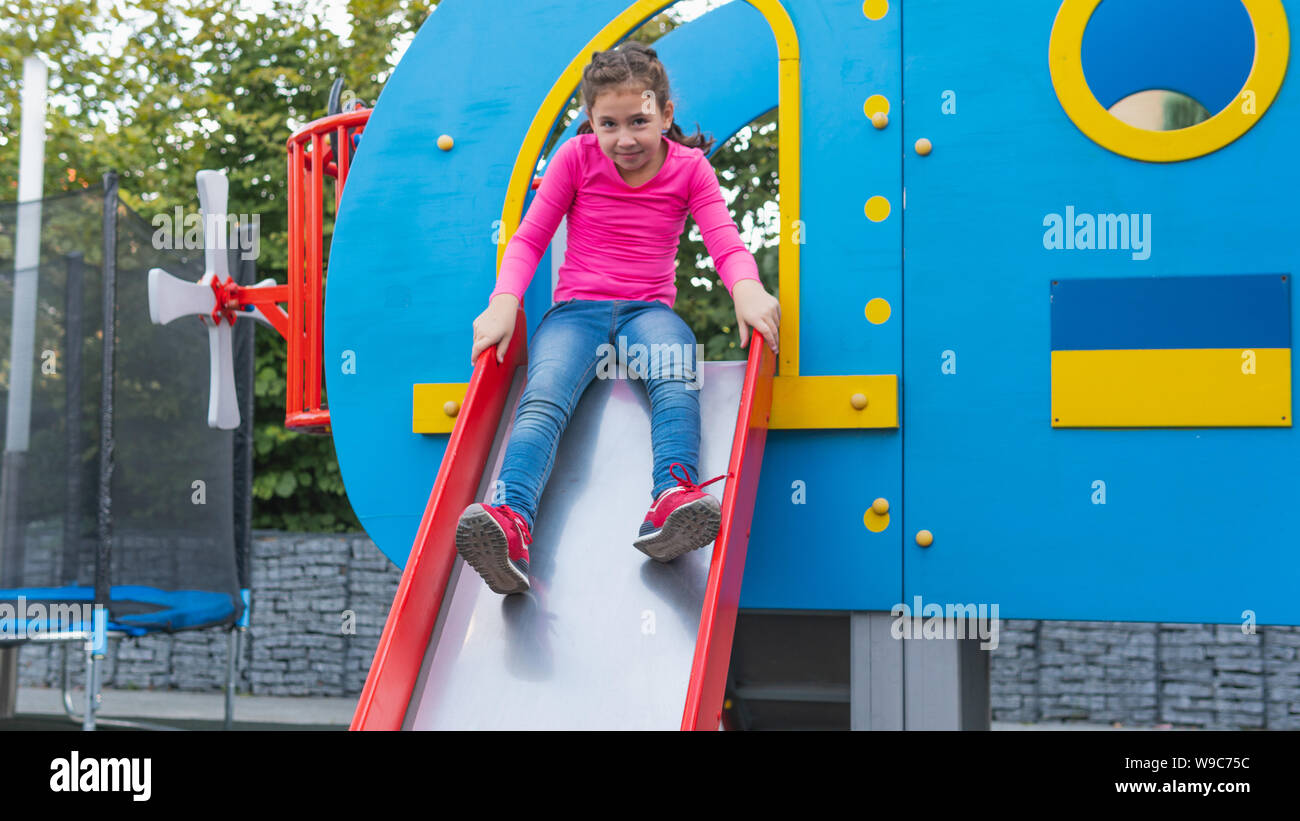Happy smiling child on playground. Happy kids playing outdoors, clear ...