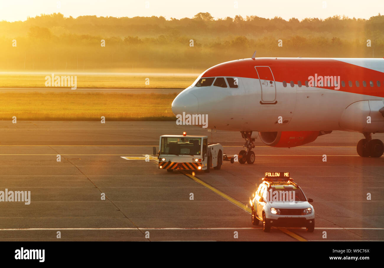 TUG Pushback tractor with Aircraft on the runway in airport Stock Photo ...