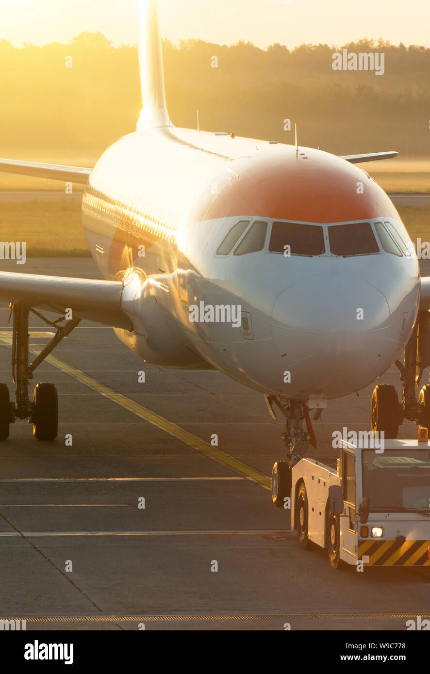 TUG Pushback tractor with Aircraft on the runway in airport Stock Photo ...