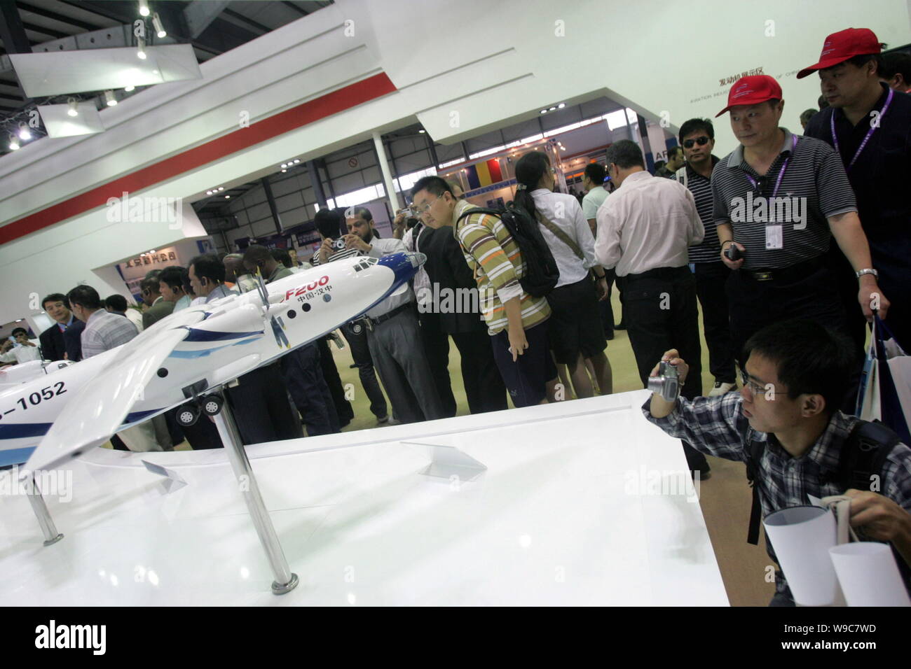 Visitors look at plane models at the stand of Aviation Industry ...
