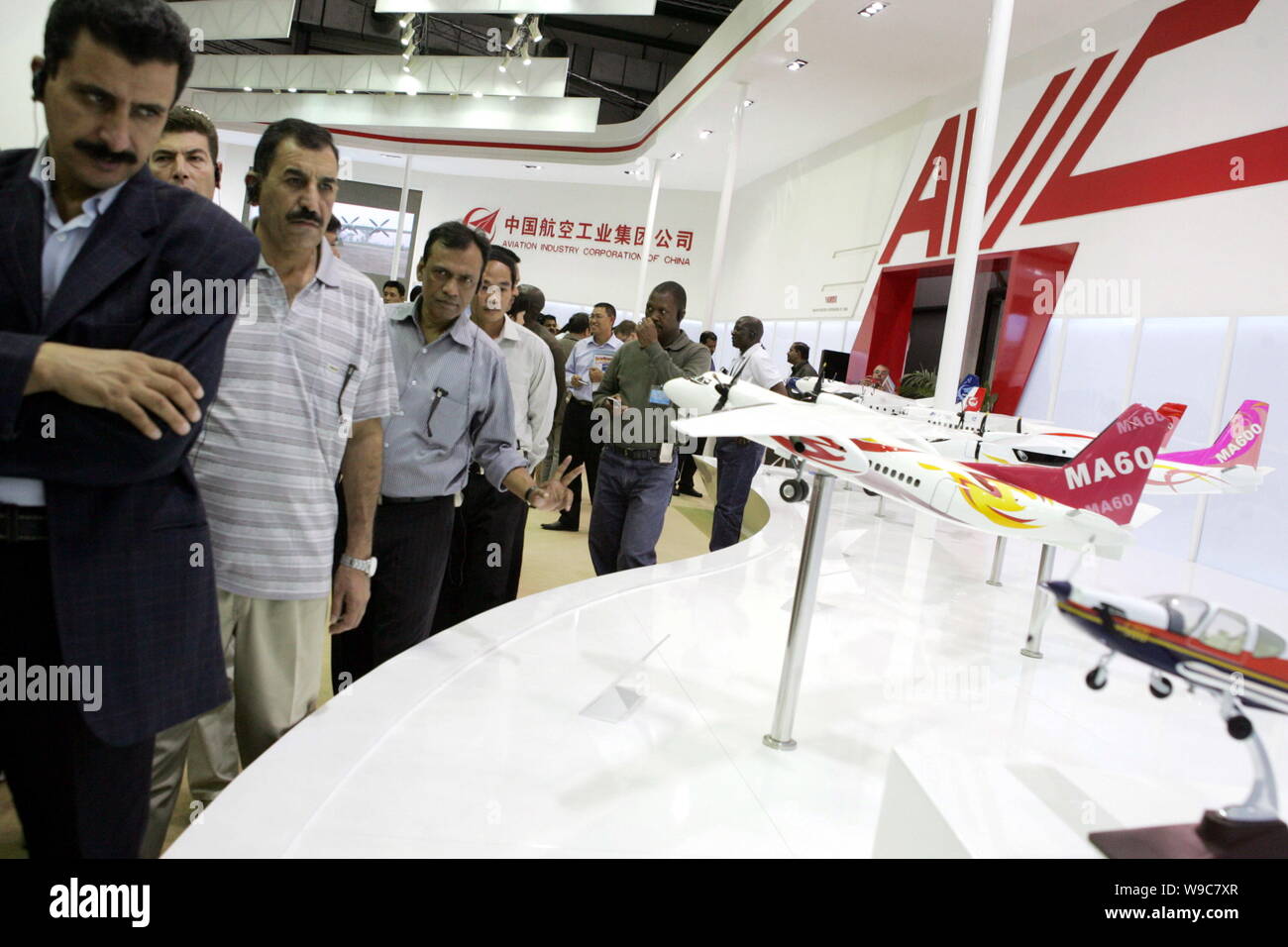 Visitors look at plane models at the stand of Aviation Industry ...