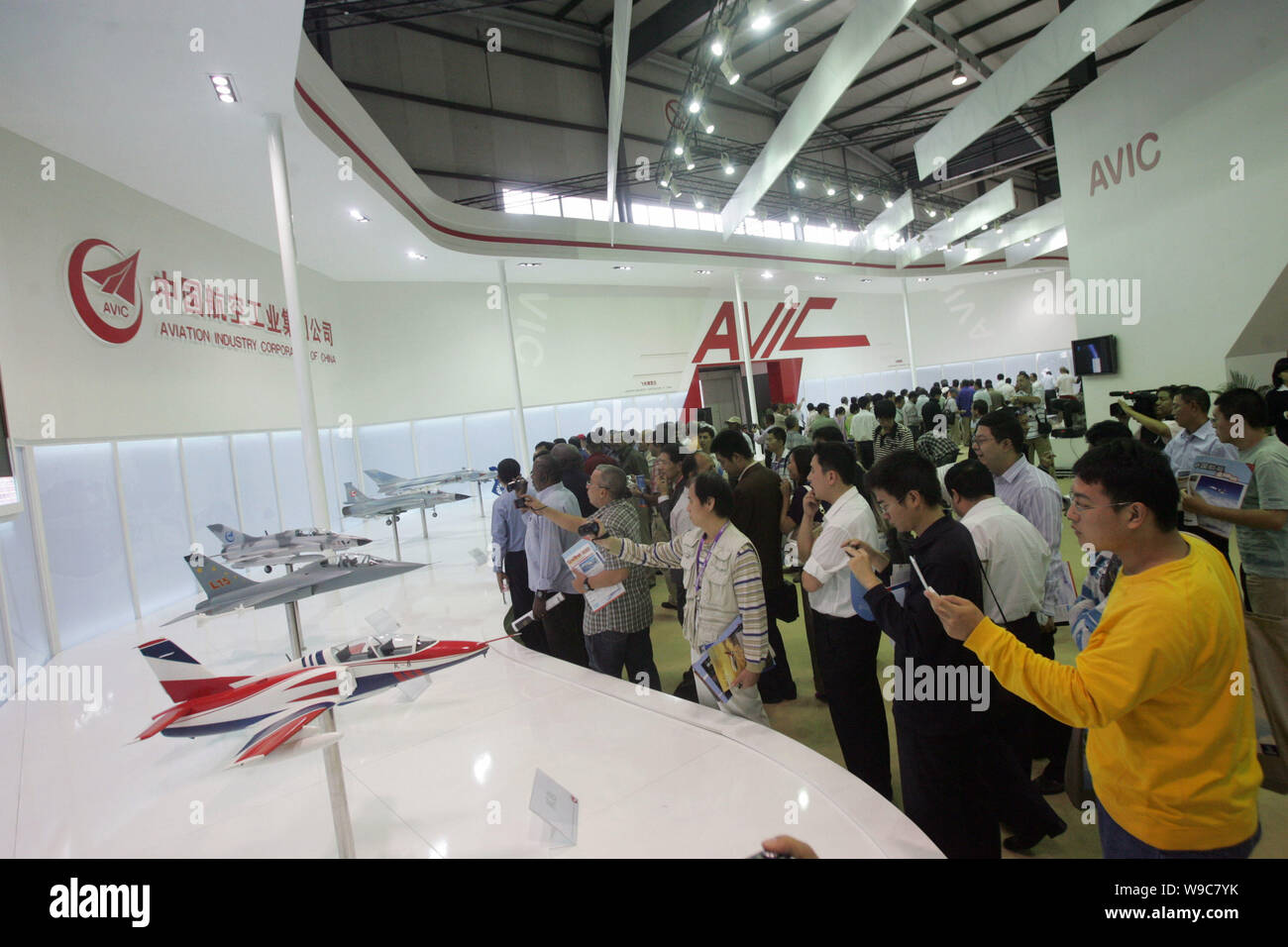 Visitors look at plane models at the stand of Aviation Industry ...