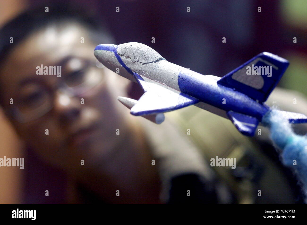 A Chinese man looks at a model fighter plane during a model exhibition ...