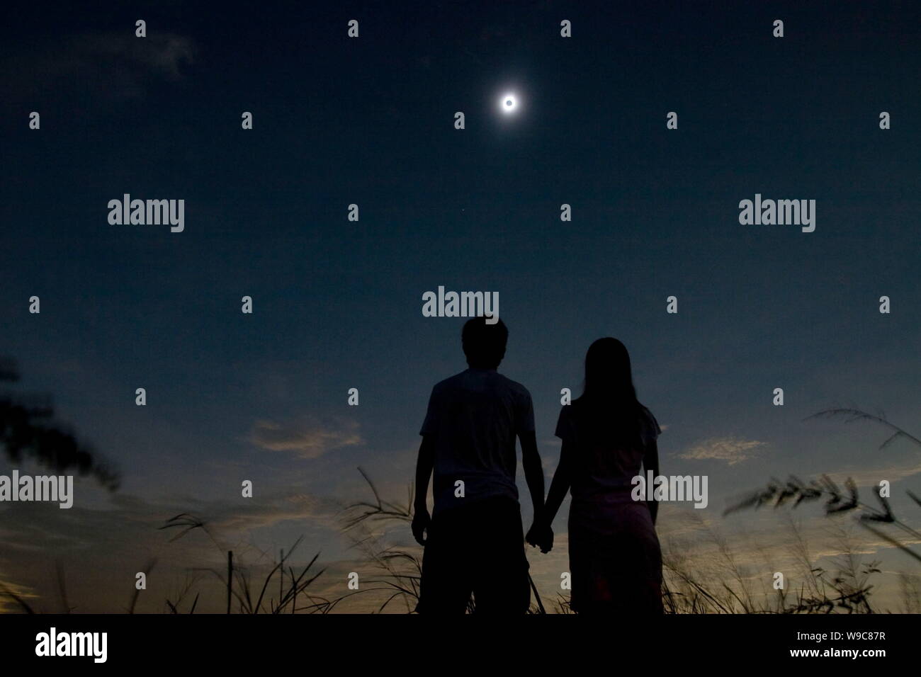A couple of Chinese lovers look at a total solar eclipse in Qianjiang ...