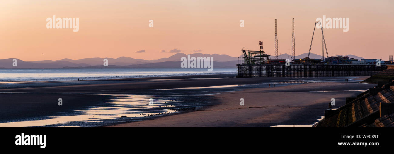 Panoramic view of a peaceful beach at sunset with Blackpool South Pier ...