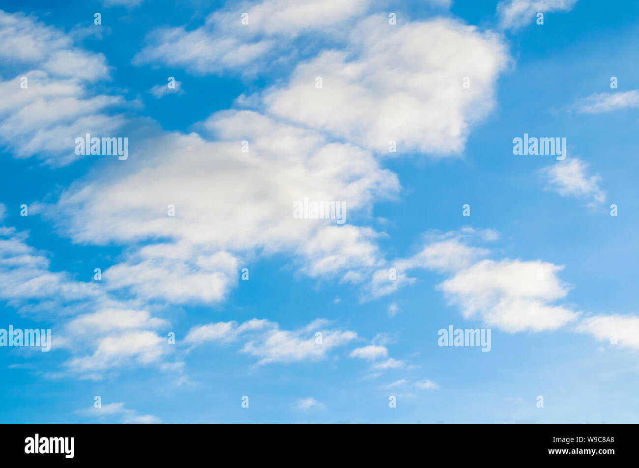 Blue dramatic sky background - white dramatic colorful clouds lit by ...