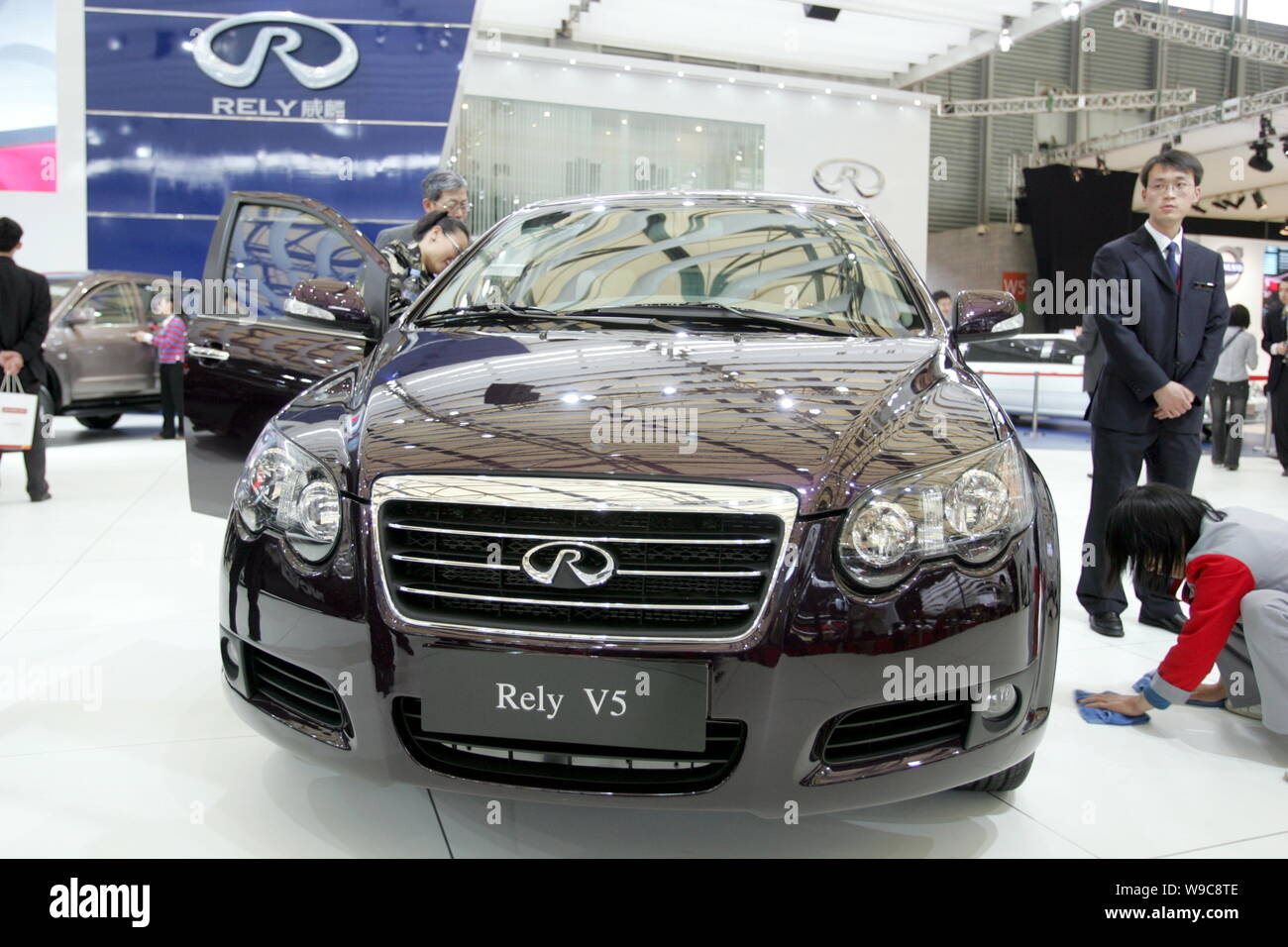 Visitors look at a Chery Rely V5 at the 13th Shanghai International ...
