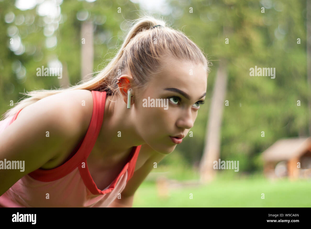 Young Woman Is Out Of Breath And Makes A Breather Bent Over While Doing