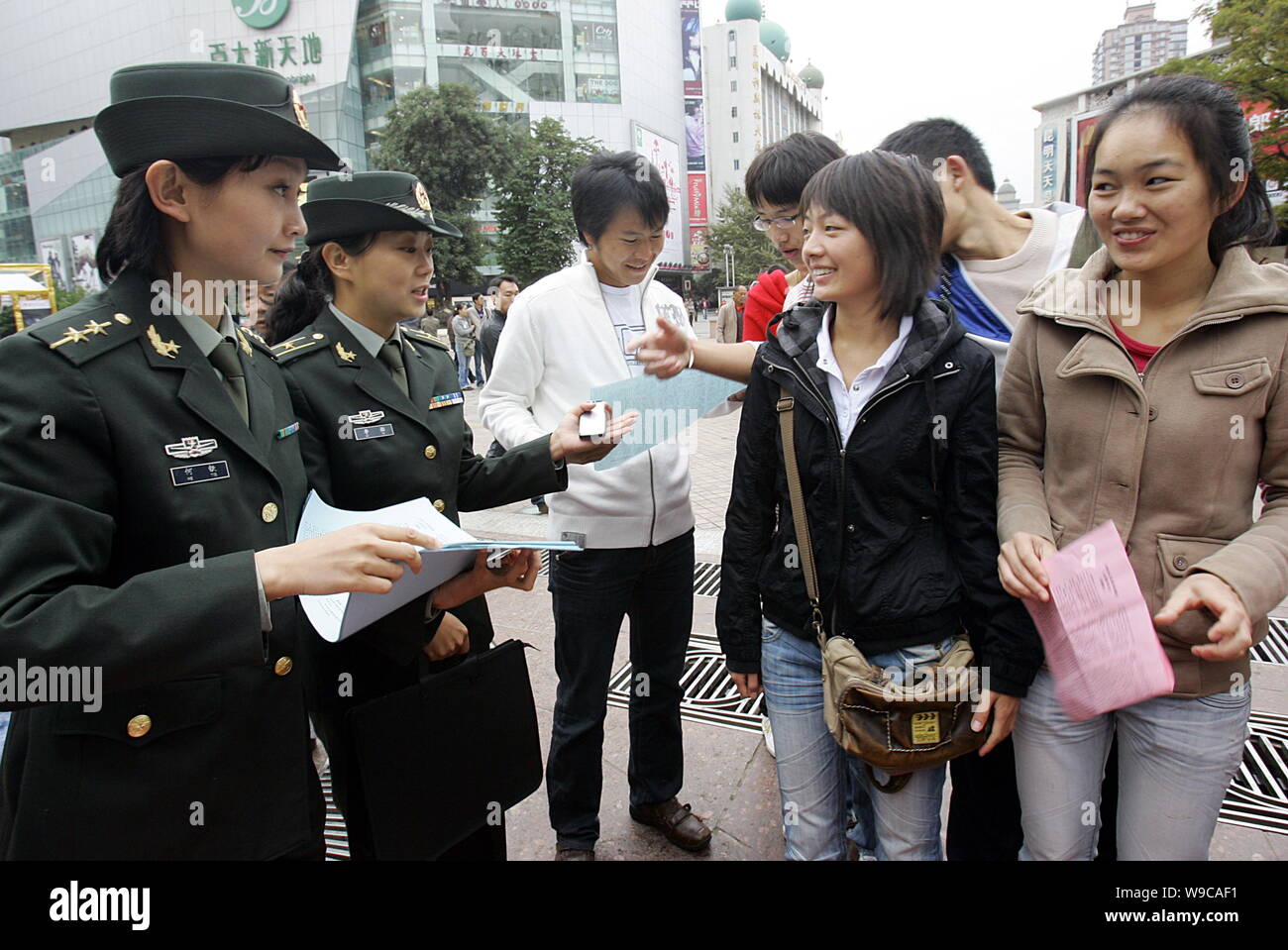 Female Chinese PLA (People Liberation Army) soldiers distribute ...