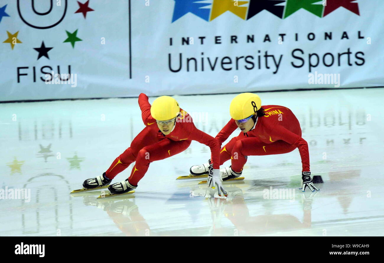 Chinas Liu Qiuhong, left, and Zhou Yang compete at the final of the ...