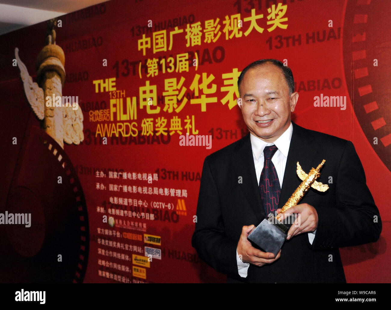 Hollywood film director John Woo holds his trophy for Best Overseas ...