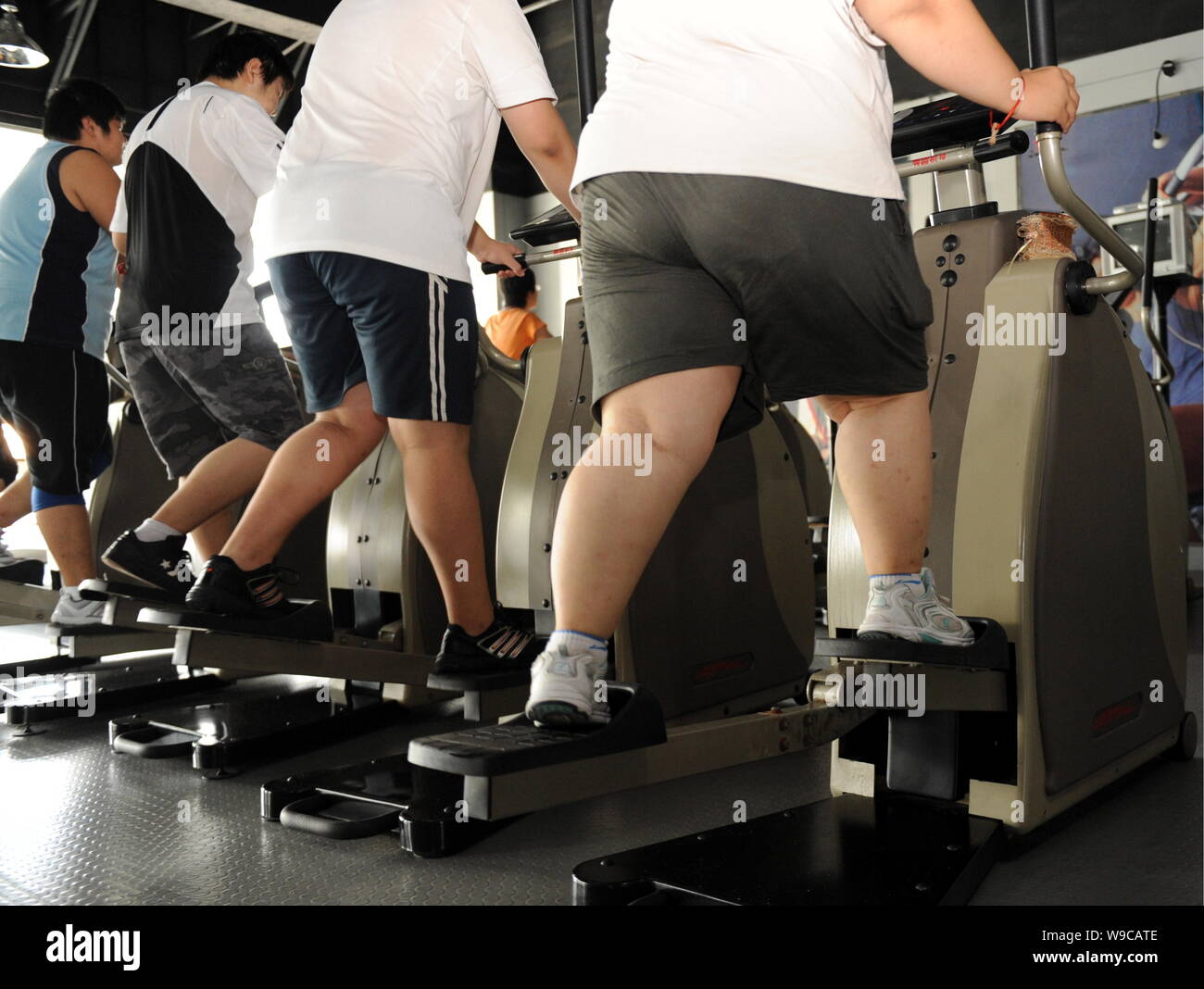 Chinese obese children exercise on steppers during a weight reduction ...