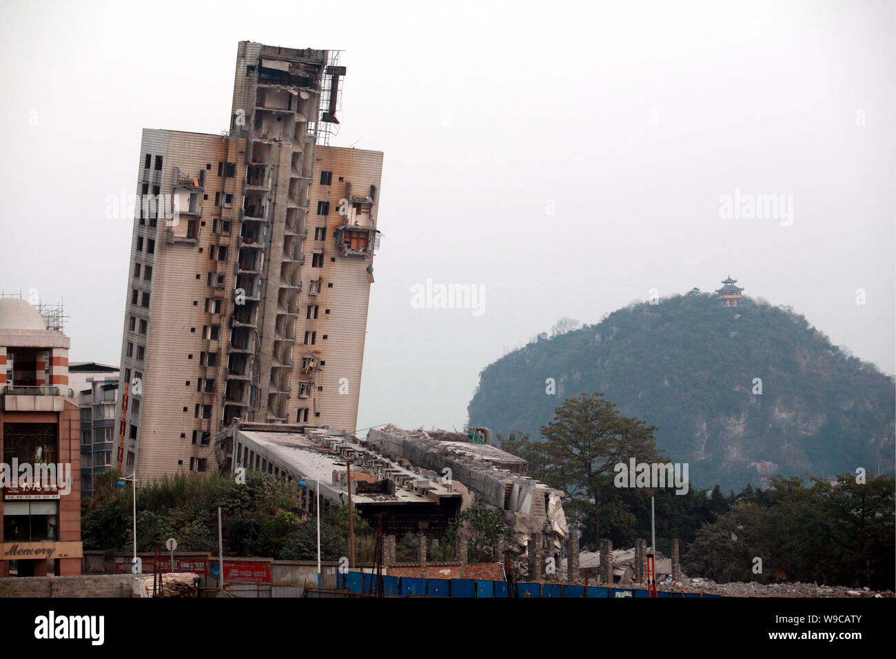 One half of a 22-story building is seen remained intact after the ...