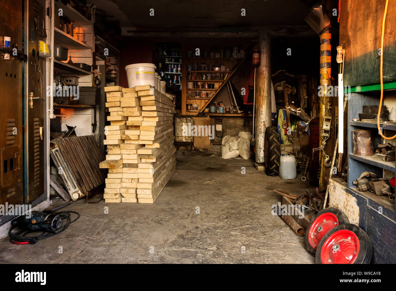 interior of a rural barn with a workshop and a repository of materials ...