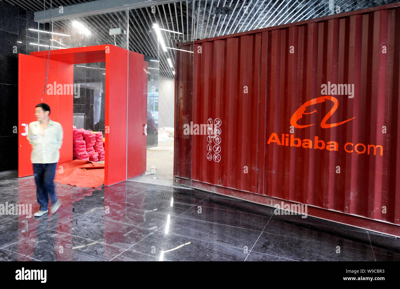 A worker walks inside the new headquarters of Alibaba.com in Hangzhou ...