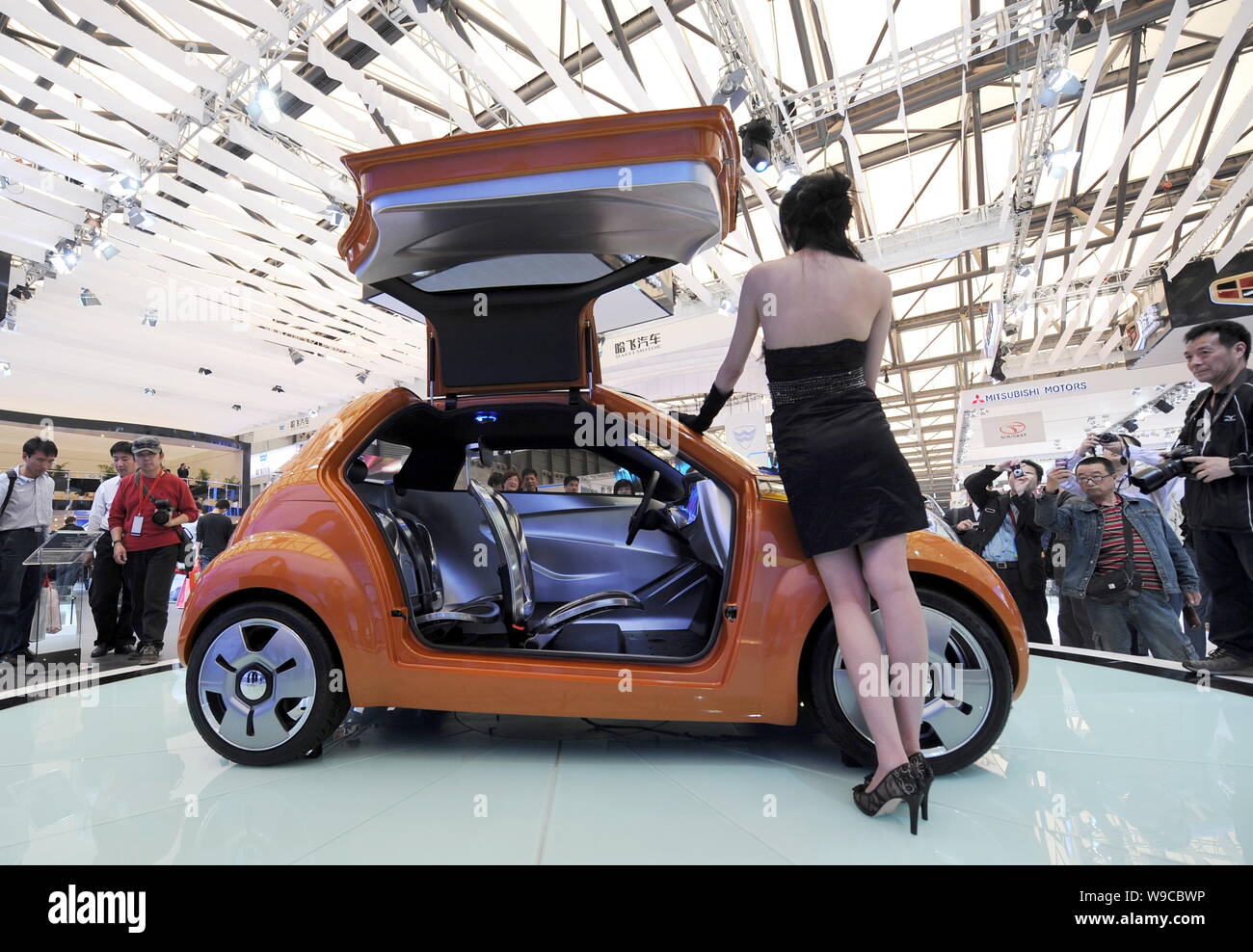Visitors look at a Geely IG (Intelligent Geely) at the 13th Shanghai ...