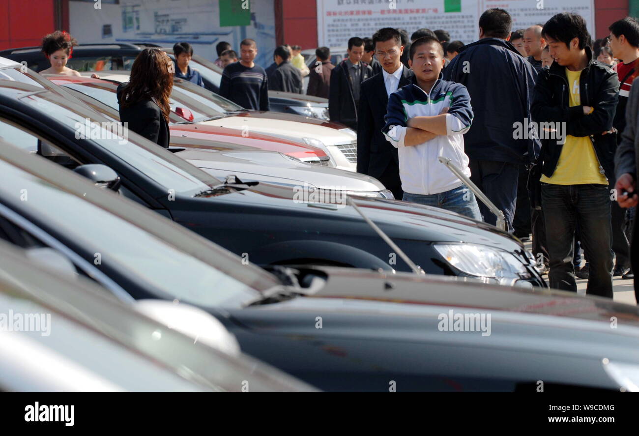 --FILE--Chinese visitors look at cars on display during an auto show in ...