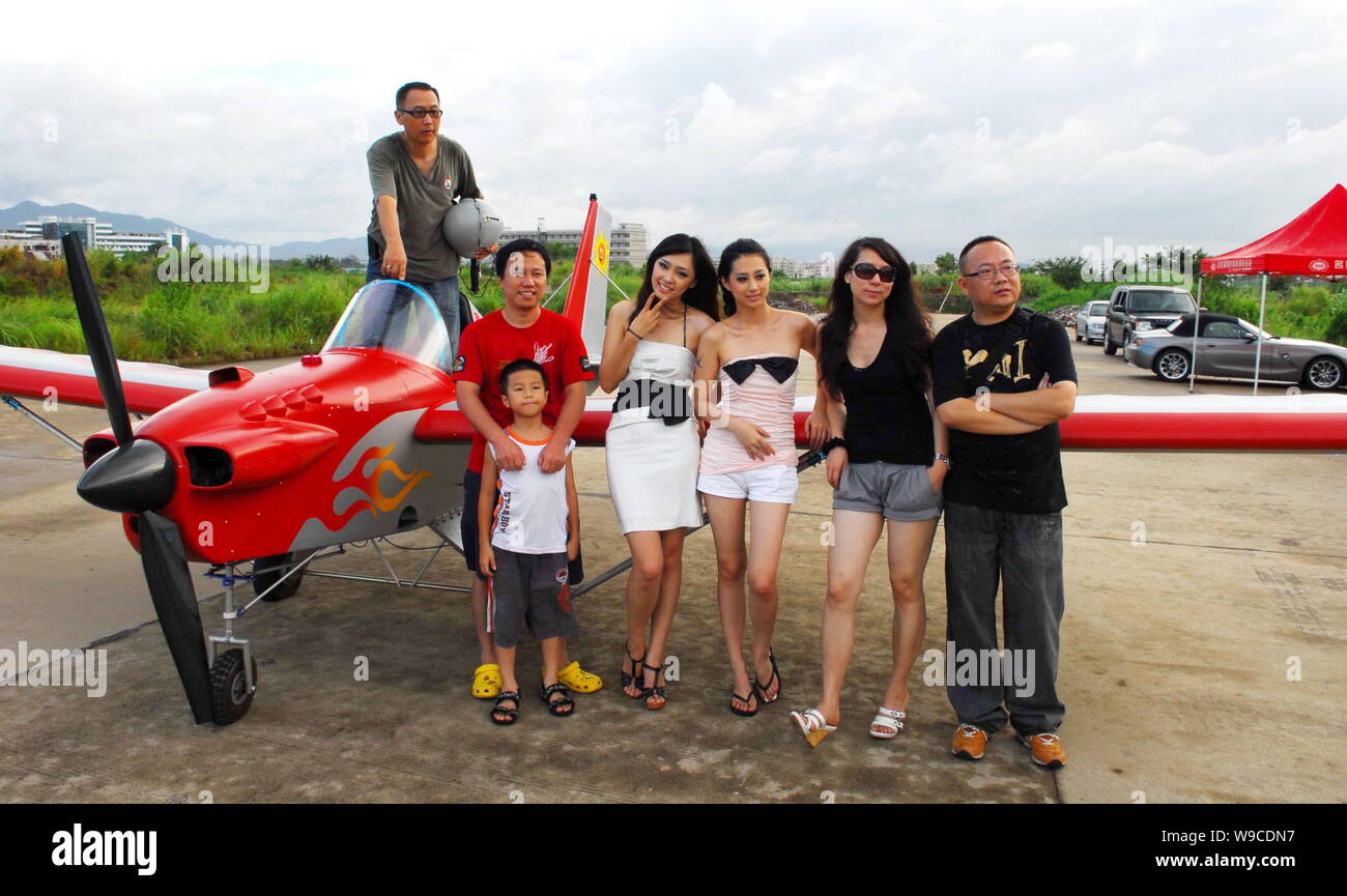 Yang Weimin, left, poses in his self-made light plane with his family ...