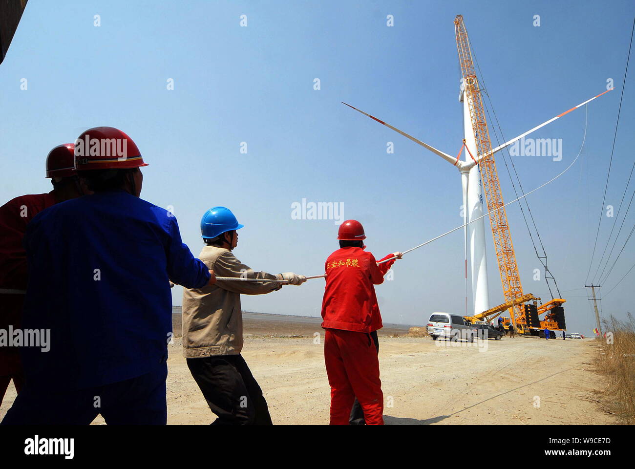 --FILE--Chinese workers are seen installing a wind power turbine at a ...