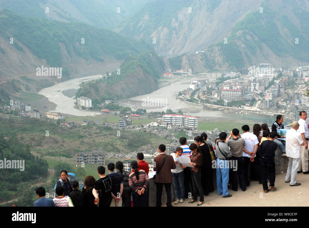 Chinese visitors on a hillside looks at the quake-devastated Beichuan ...