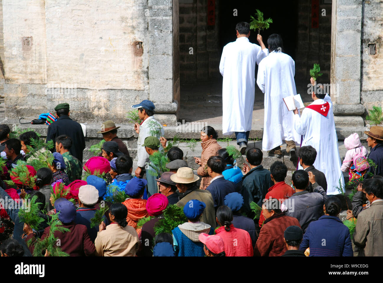 Chinese priests and Catholics walk into the Cizhong Catholic Church ...