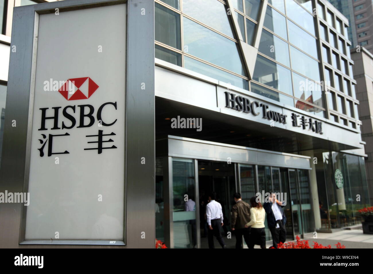 --FILE--A signboard of HSBC is seen in front of the HSBC Tower in the ...