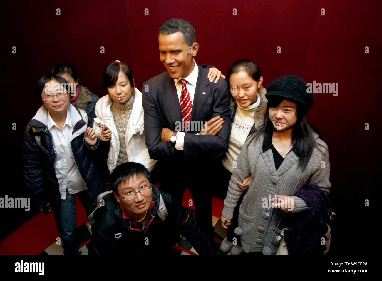 Chinese visitors pose next to a wax figure of U.S. President Barack ...