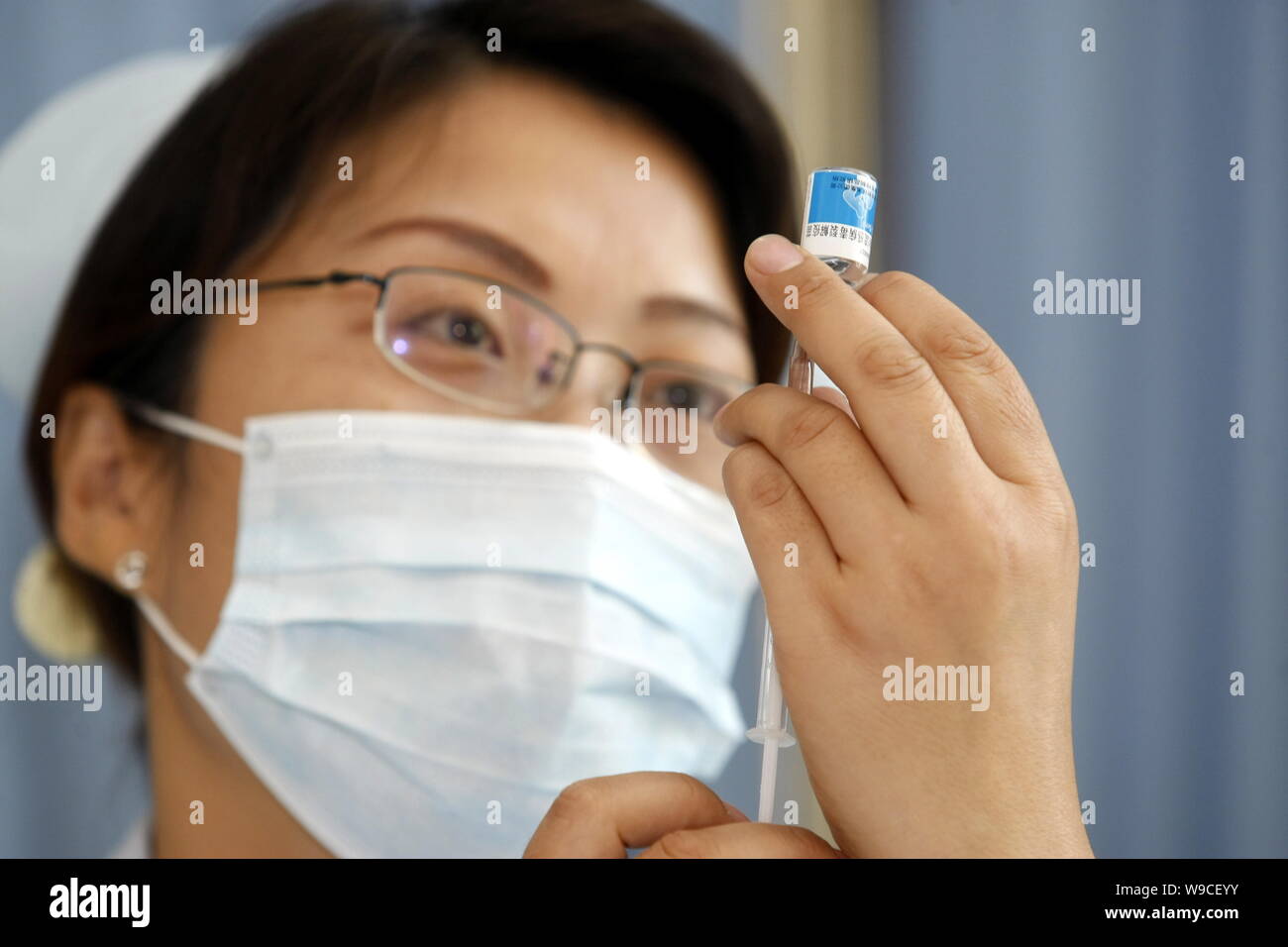 A Chinese nurse prepares an injection of the H1N1 flu vaccine for a ...